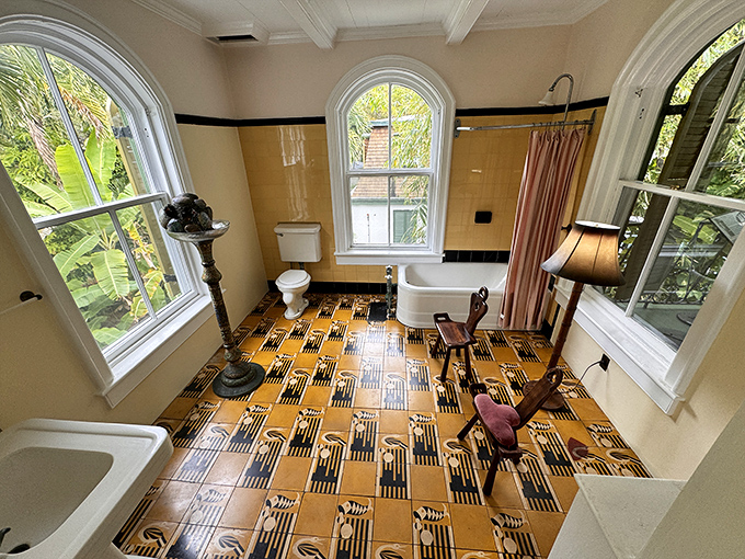The bathroom's bold yellow and black tiles scream 1930s luxury. Even the fixtures look like they could tell stories of Hemingway's morning routines.