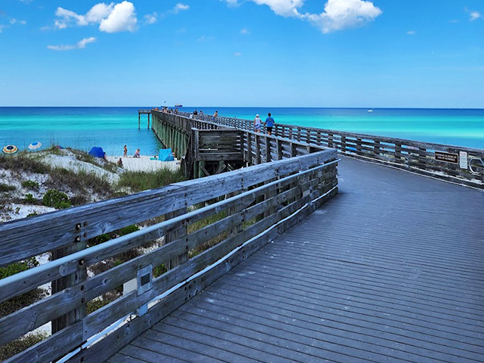 The wooden boardwalk extends like an invitation to adventure, promising spectacular views with every step toward the horizon.