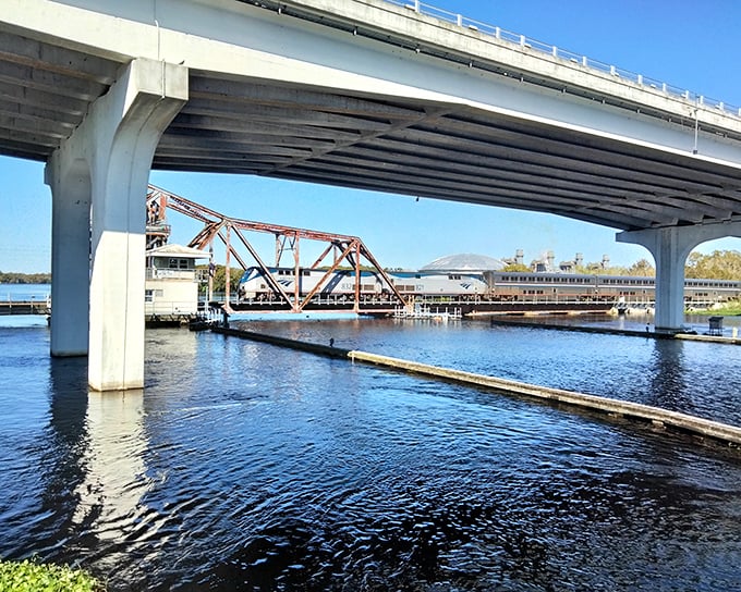 Sunlight plays on the underside of the elevated highway, creating shadows that seem to move with minds of their own.