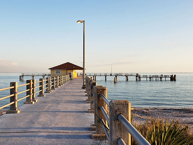 The fishing pier stretches toward the horizon like a runway to paradise, promising both solitude and the day's fresh catch.