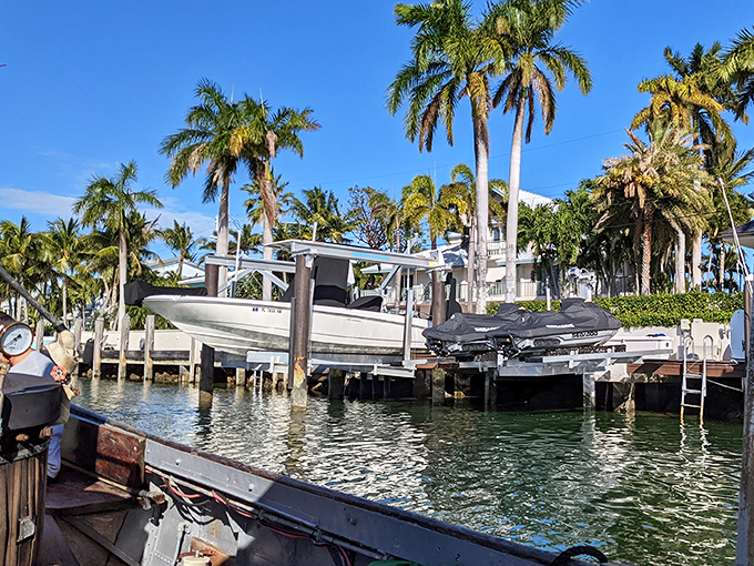 Cruising past million-dollar waterfront homes, the humble African Queen reminds us that true character outshines mere luxury every time.