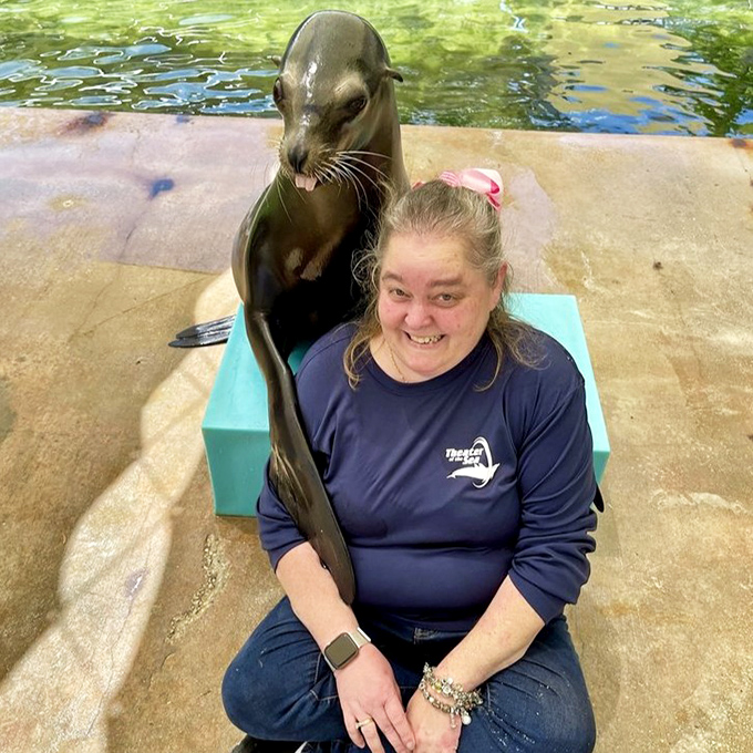 This sea lion seems to be sharing a heartwarming moment with a park visitor. Those whiskers tickle, but the memory lasts forever.