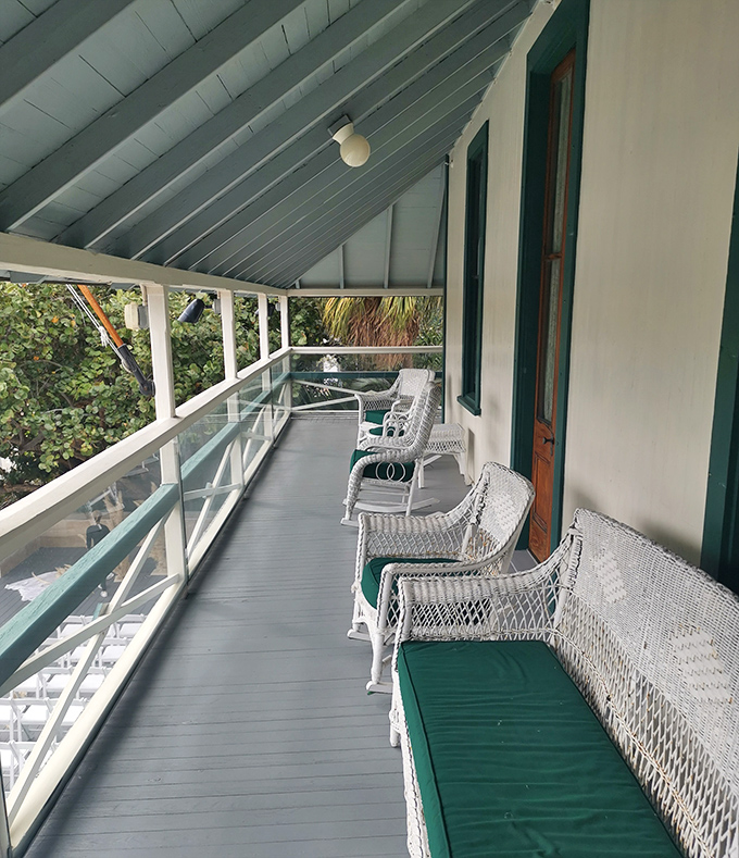 White wicker chairs line the veranda, inviting visitors to slow down and remember when "social networking" meant actual face-to-face conversations.