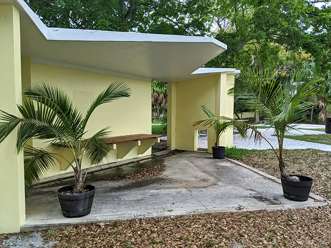 The minimalist design of this yellow structure with its bench seating creates an unexpected oasis of calm within the bustling park.