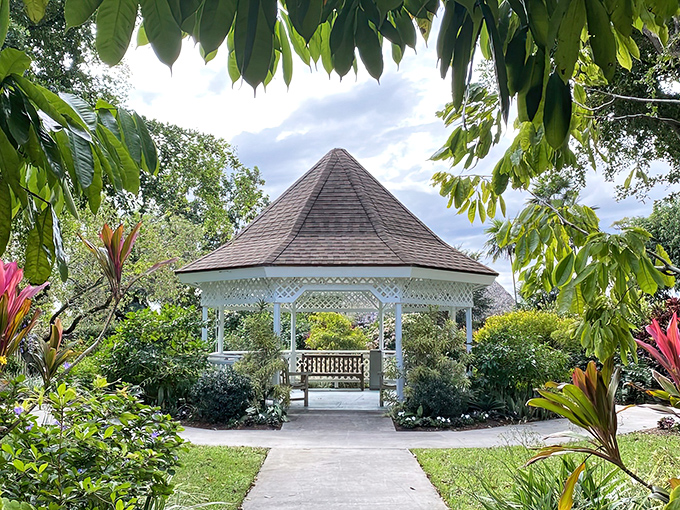 The classic white gazebo stands like a wedding cake amid the greenery, offering shade and the perfect backdrop for "I was here" photos.
