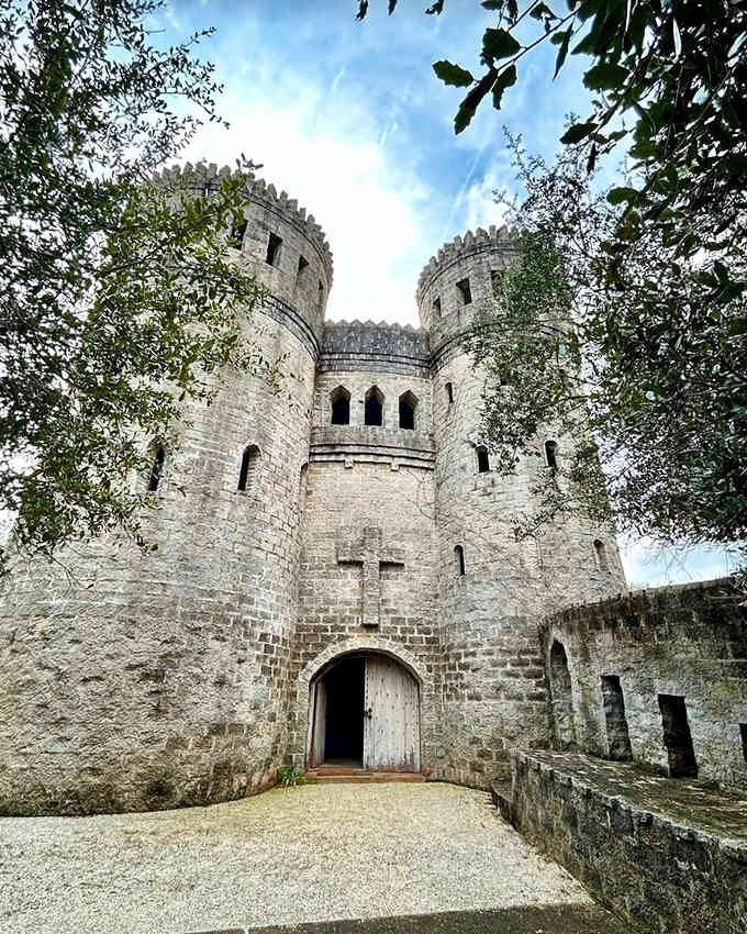Castle Otttis rises dramatically from the landscape, its rough stone towers and narrow windows creating an authentic medieval silhouette against the sky.