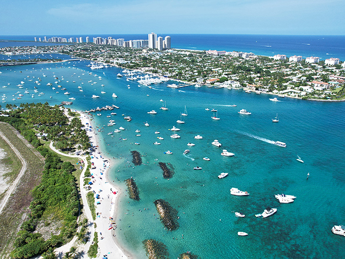 Peanut Island's stunning aerial view reveals a boater's paradise where azure waters meet pristine beaches &ndash; Miami's skyline shimmers in the distance like a mirage.