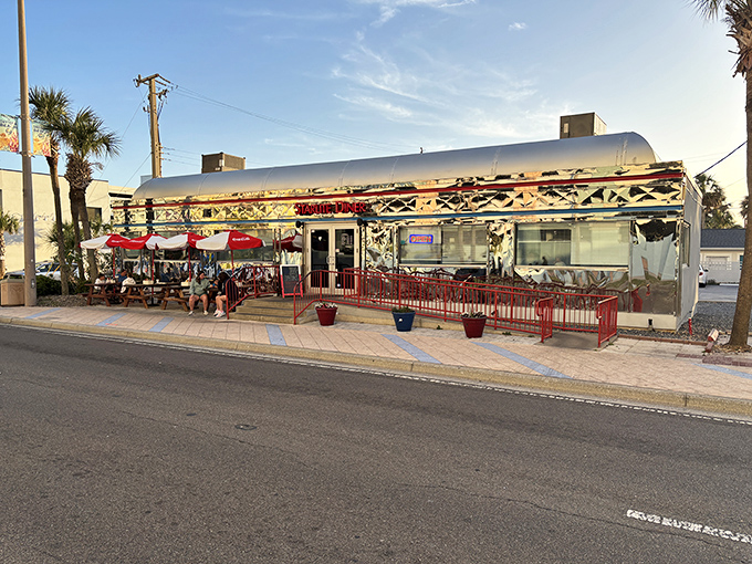 Starlite Diner gleams like a silver bullet against the palm trees, a metallic time machine serving breakfast all day just steps from Daytona's famous beach.