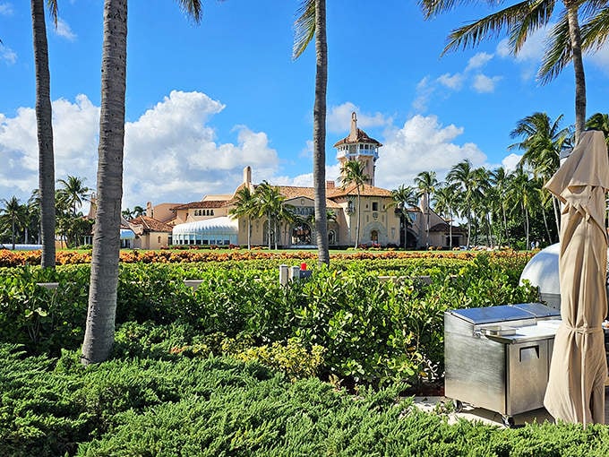 Lush gardens and palm trees frame Mar-a-Lago's famous silhouette, a private paradise between ocean and lake.