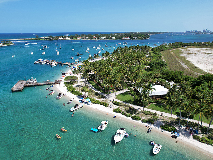 The perfect weekend escape! Peanut Island's crystal-clear waters create a natural swimming pool where boats gather and beachgoers bask in Florida sunshine.