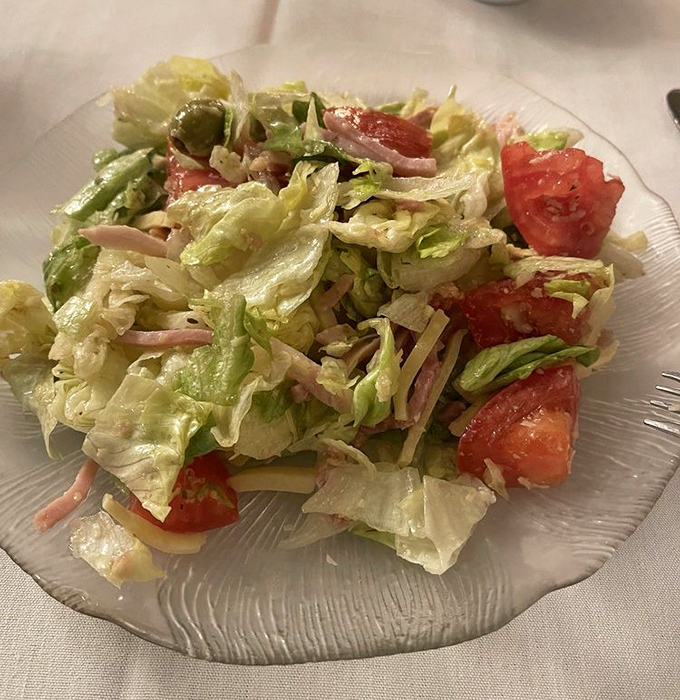 The famous 1905 Salad isn't just tossed&mdash;it's choreographed tableside, a fresh medley of crisp lettuce, julienned ham, and that garlicky dressing worth writing home about.