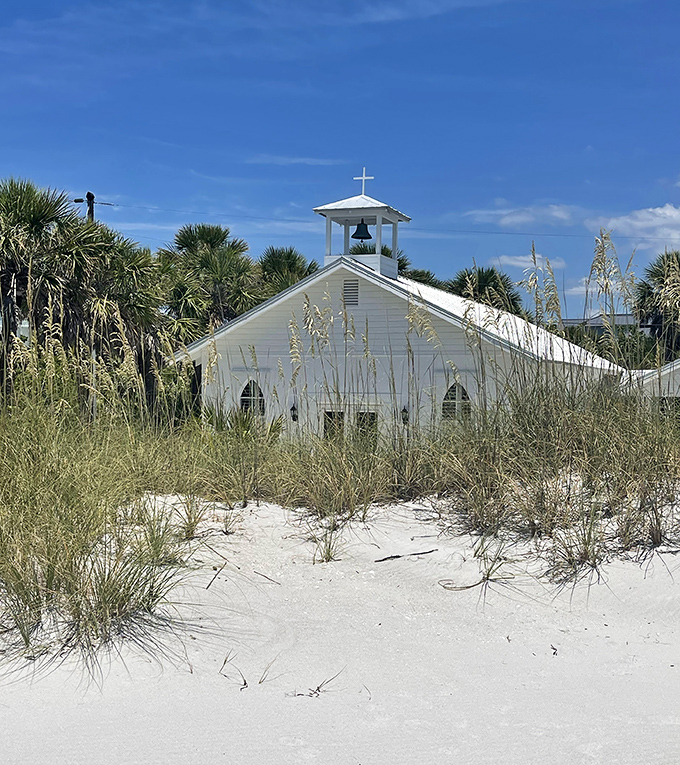 Amory Memorial Chapel stands as a serene sanctuary amid palm trees, offering quiet reflection for those needing a break from beach adventures.