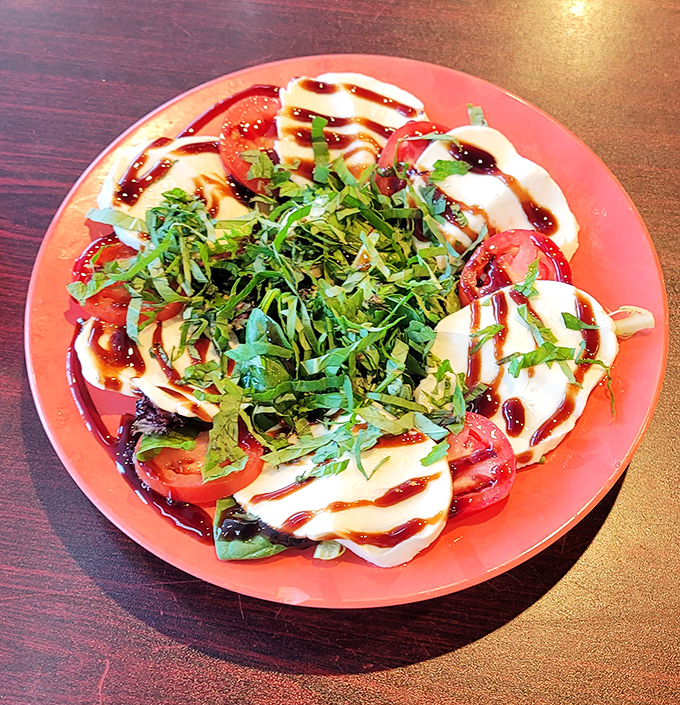 Fresh tomatoes and mozzarella drizzled with balsamic and herbs &ndash; this Caprese salad offers a refreshing counterpoint to pizza indulgence.