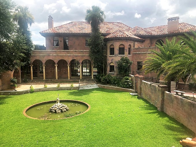 The central courtyard feels plucked from a European villa, its fountain and manicured lawn creating a tranquil oasis.