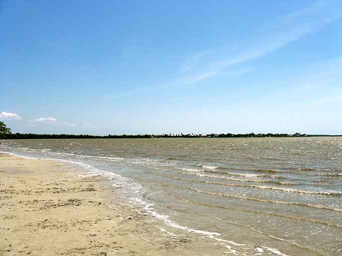 This quiet beach offers the kind of solitude that makes you wonder why anyone would choose a crowded resort over this peaceful perfection.