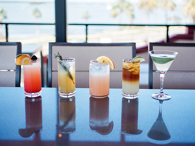 Cocktails lined up like colorful sunset contenders, each vying to be your companion for that golden hour magic.