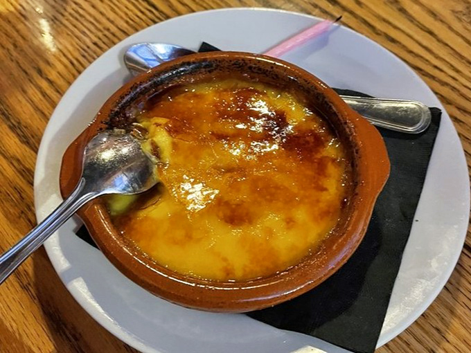 The crema catalana's caramelized top shatters with a satisfying crack, revealing silky custard beneath &ndash; Spain's delicious answer to cr&egrave;me br&ucirc;l&eacute;e.