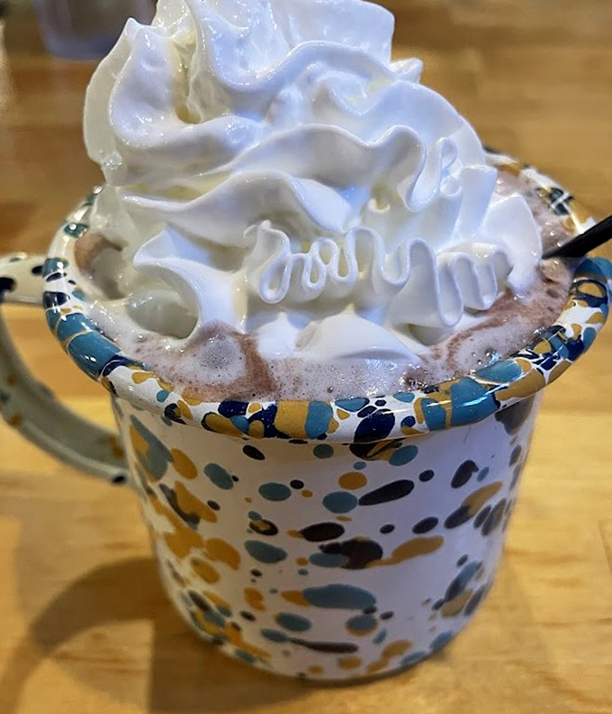 A mug of hot chocolate crowned with a cloud of whipped cream – the perfect companion for pancake adventures.