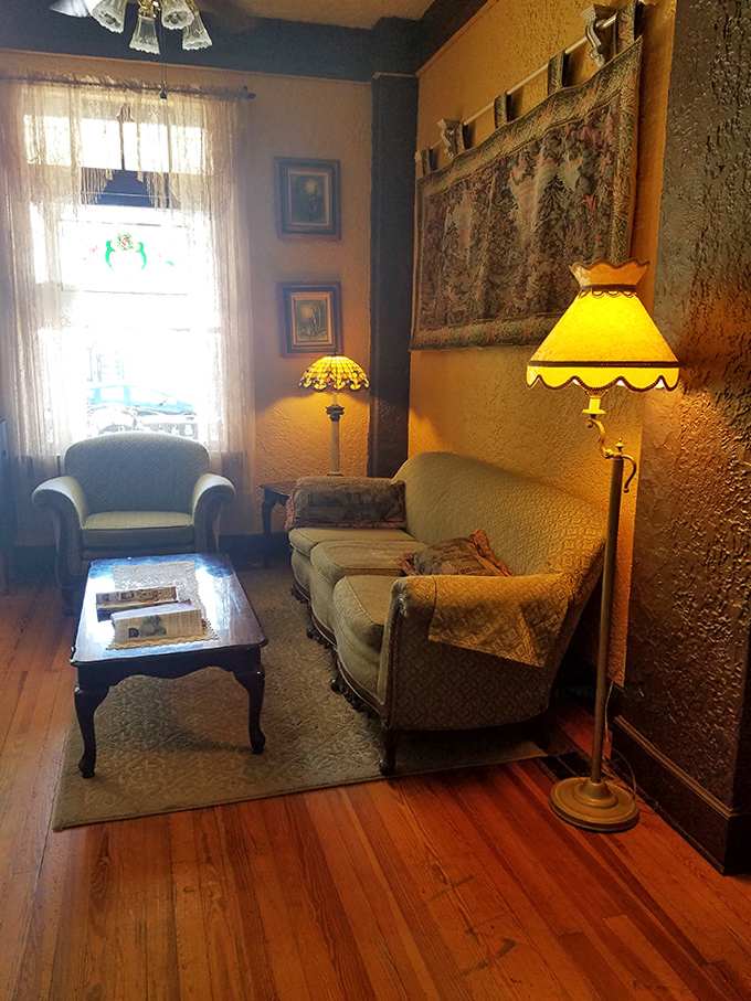 Sink into these vintage chairs where mediums and curious travelers have contemplated life's mysteries for generations. That lamp casts more shadows than light, exactly as intended.