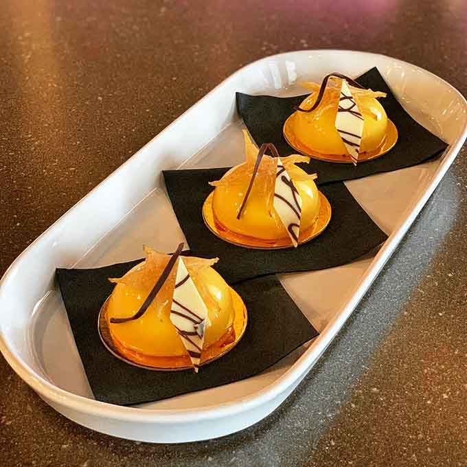 Mango mousse domes that look like tiny edible works of art, proving dessert can be fancy and fun simultaneously without being pretentious.