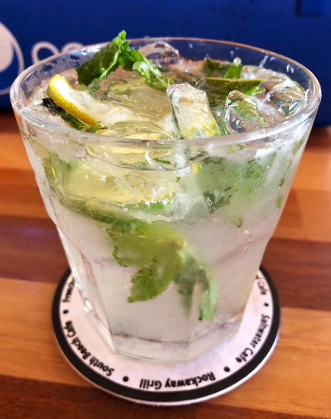 The mojito arrives like a refreshing breeze, mint leaves dancing among ice cubes while lime adds that perfect citrus punch.