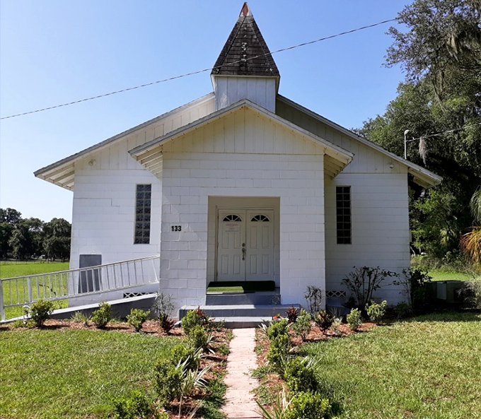 Simple white church with a modest steeple that has witnessed countless life celebrations and community gatherings.