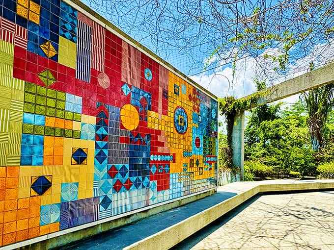 This vibrant ceramic tile mural adds artistic flair to the landscape, proving that gardens can be galleries without losing their natural charm.