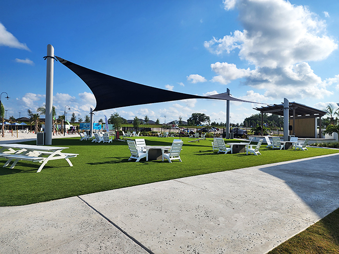 The thoughtfully designed rest area offers shaded respite under sail canopies, where Adirondack chairs invite weary swimmers to recharge.