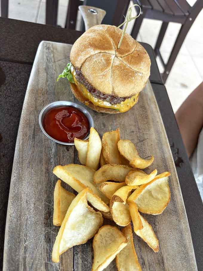 This burger and crispy chips arrive on a rustic board, turning casual dining into something that feels special and satisfying.