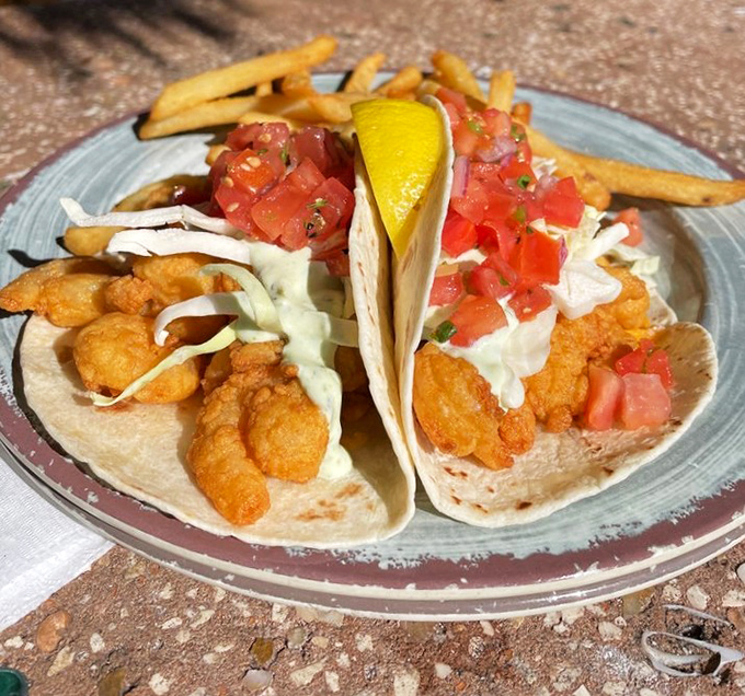 Golden fried shrimp nestled in soft tortillas with crisp cabbage, fresh pico de gallo, and a creamy sauce &ndash; beach food elevated to an art form.