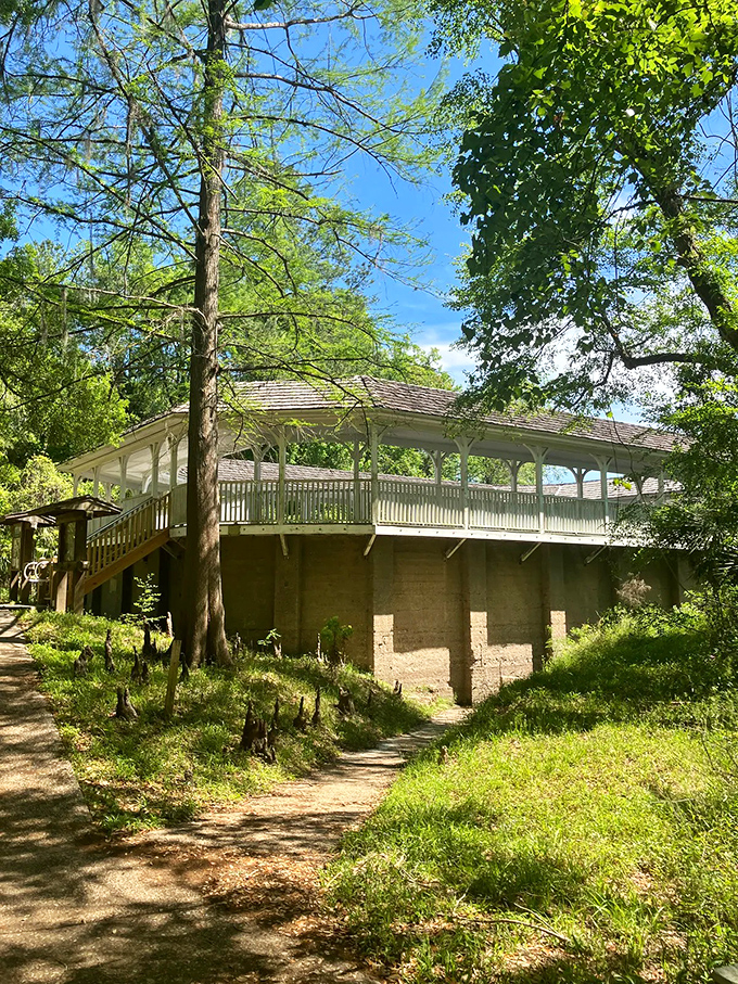 Summer greenery embraces the octagonal structure, its geometric precision a striking contrast to the untamed landscape surrounding it.