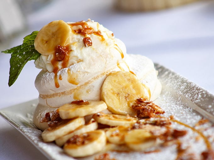 This pavlova dessert with bananas and caramel is basically a sweet cloud that landed on your plate.