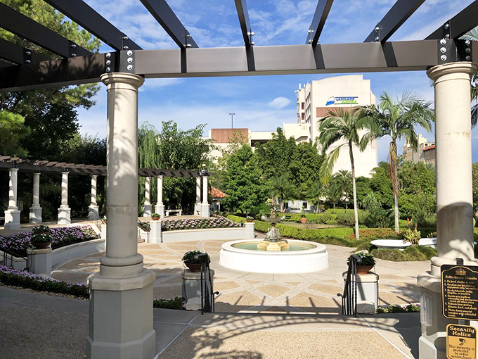 Elegant columns support a pergola that frames garden views, creating the perfect balance between structured design and natural beauty.