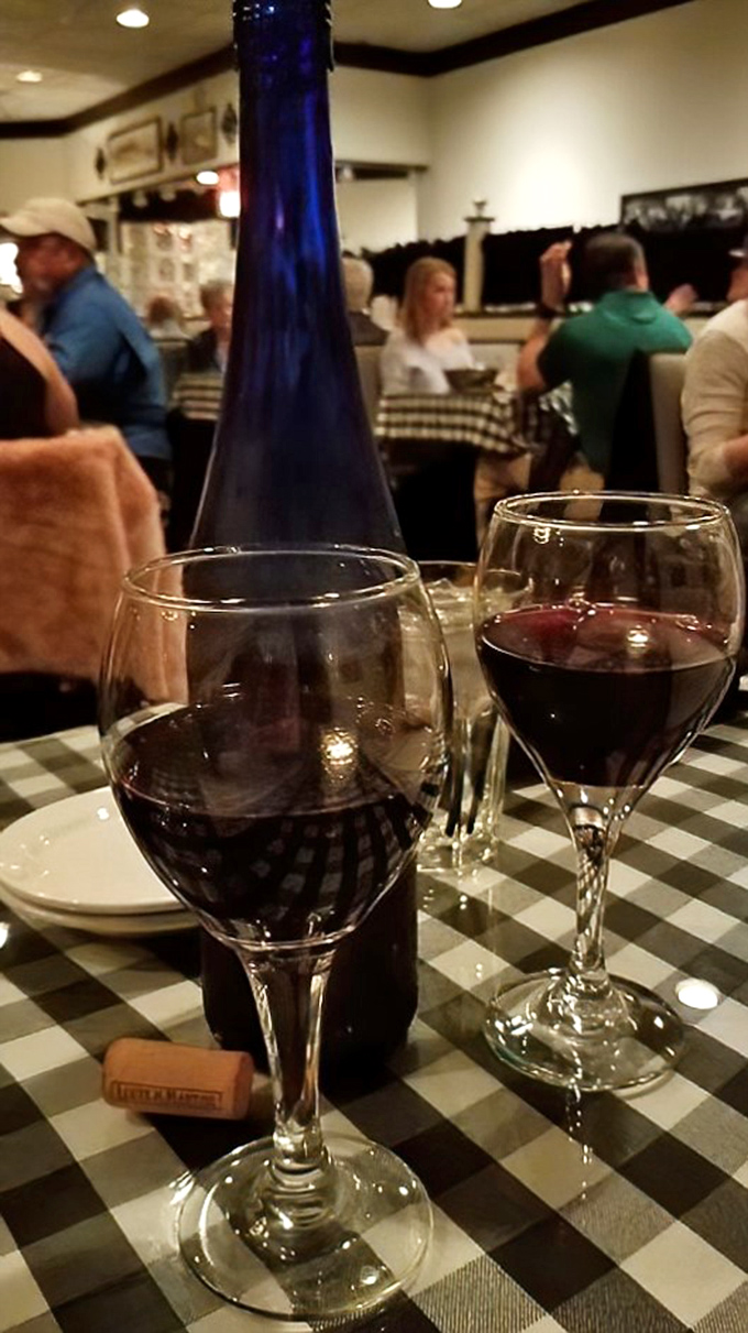 Ruby liquid catches the light in elegant stemware &ndash; the perfect companion for an evening of carnivorous delights and warm conversation.