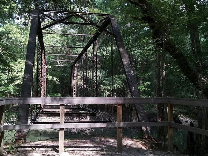 This wooden barrier stands as both invitation and warning &ndash; adventure lies ahead, but the bridge's structural integrity remains questionable.