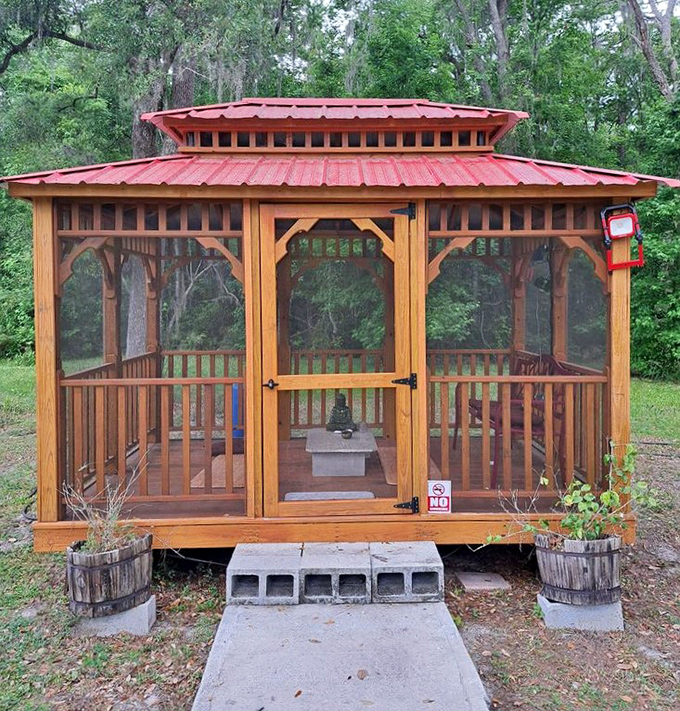 This charming screened gazebo offers a perfect spot for quiet reflection or shelter from Florida's occasional afternoon showers.