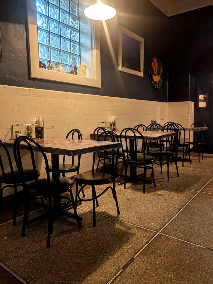 The dining area balances historic charm with modern comfort, where hospital corridors now host hungry pizza pilgrims.