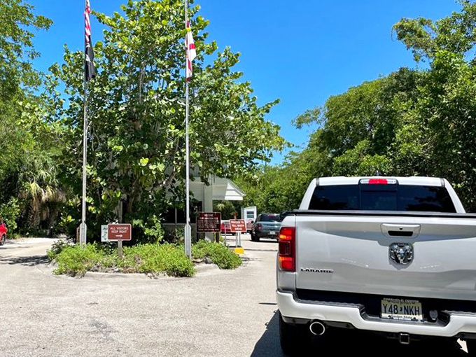 Welcome committee: American flags flutter at the park entrance, where visitors' vehicles line up for their dose of Florida sunshine.