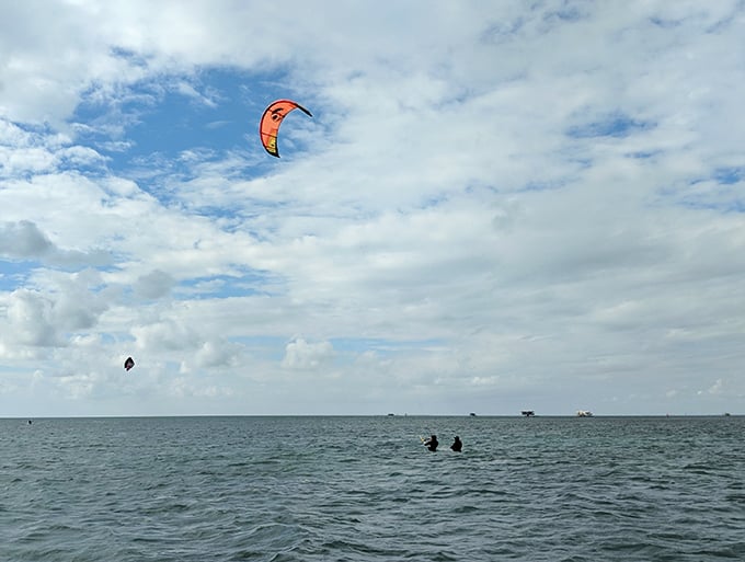 Kiteboarders harness the wind near Stiltsville, adding their own colorful chapter to these waters' long history of human ingenuity.