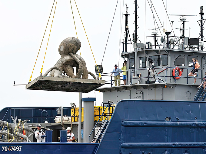 This octopus sculpture stretches its tentacles across the sandy bottom, creating the perfect underwater playground for curious marine life.