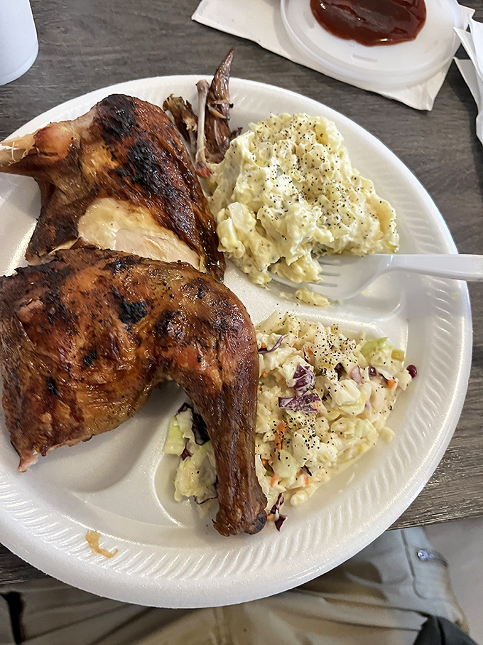 Golden-skinned chicken shares the spotlight with two types of slaw, proving poultry deserves respect in the barbecue universe too.