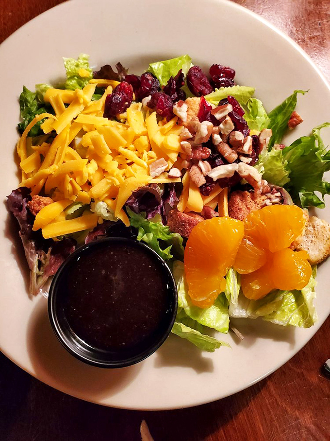 A house salad that tells Florida's agricultural story &ndash; crisp greens, sharp cheddar, sweet mandarins, and tart cranberries create a perfect prelude to heartier fare.