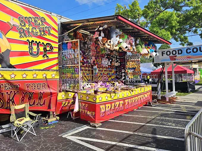 Carnival game booths tempt festival-goers with colorful prizes at the Sacred Heart Spring Festival, bringing old-fashioned fun to Pinellas Park.