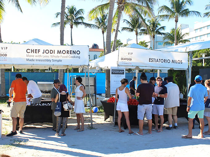 Celebrity chef stations draw eager food enthusiasts hoping to taste creations from culinary masters in this beachside paradise setting.