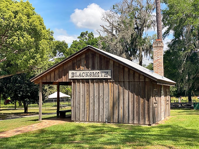 The blacksmith shop stands ready for demonstrations, its wooden structure housing the tools that shaped pioneer Florida's metal necessities.