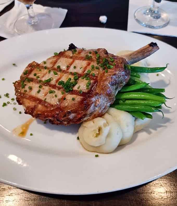 A perfectly grilled pork chop with green beans shows that classic combinations never go out of style for good reason.