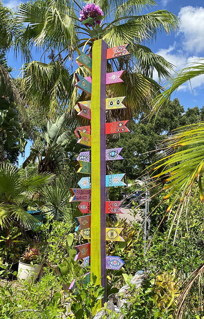This rainbow signpost points to everywhere and nowhere at once &ndash; the perfect navigation system for a place where getting lost is the point.