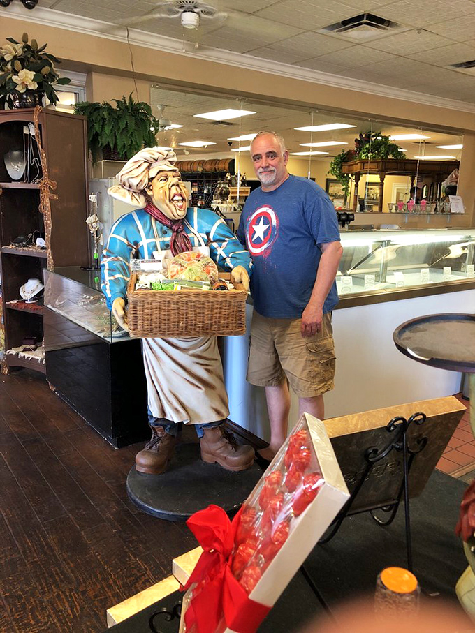 A visitor poses with the chef statue, the unofficial greeter who's witnessed countless sugar-induced smiles over the decades.