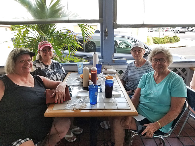The patio at Dockside Dave's: where strangers become friends over shared appreciation of grouper and Gulf Coast sunshine.