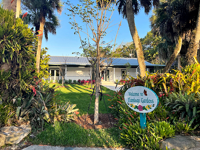 Welcome to paradise! The entrance to Flamingo Gardens promises tropical adventures beyond the sign, where Florida's wild beauty awaits discovery.